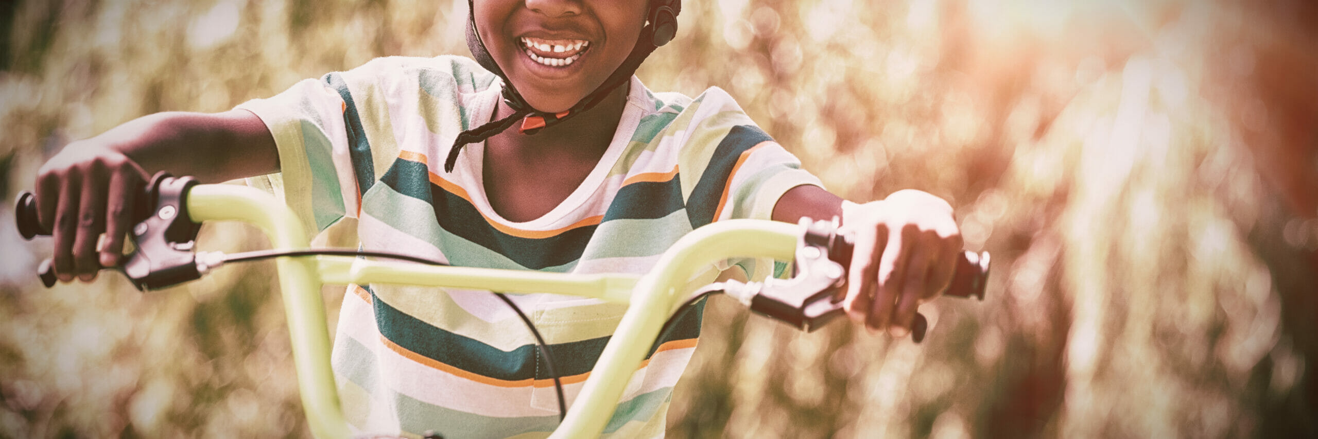 smiling boy on bicycle - NC Vision Zero